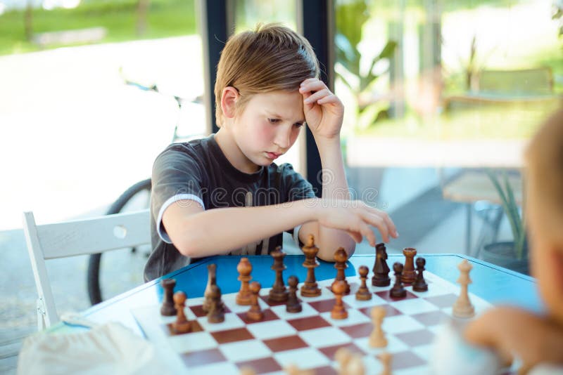 Boy playing chess game stock image. Image of open, chessboard - 255235857
