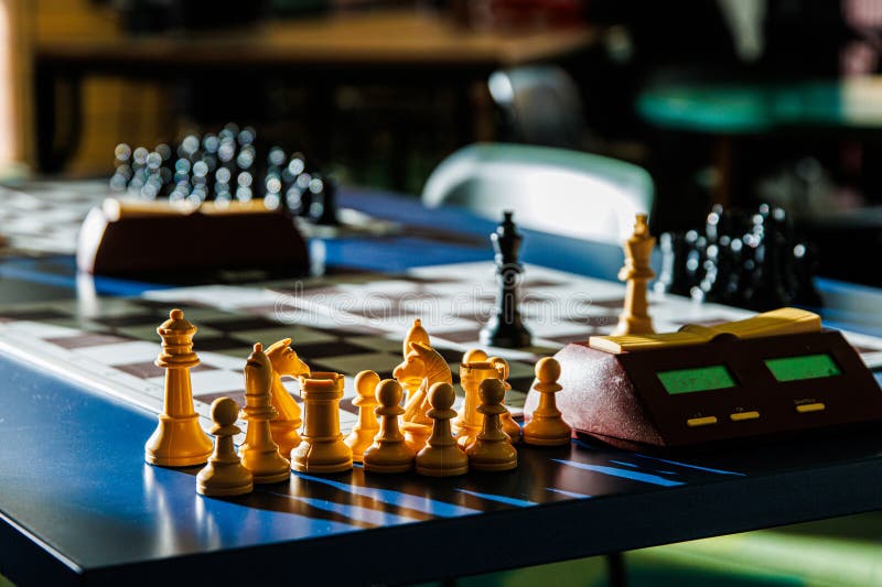 Chess Pieces Illuminated by Sunlight on a Tournament Table with Blurred ...