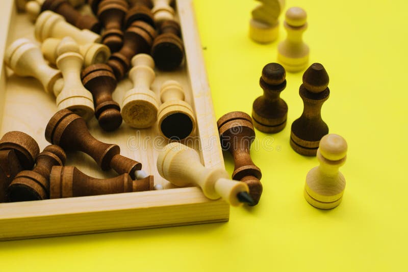 Chess Pieces are Scattered on a Yellow Background. Black and White ...