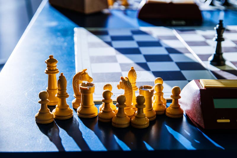 Chess Pieces in Sunlight on a Blue Tournament Table after the Endgame ...