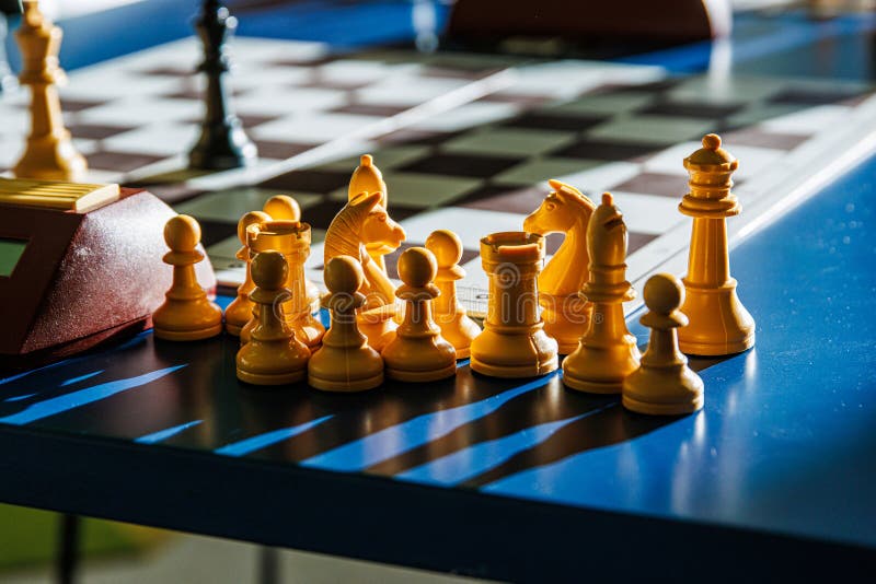 Chess Pieces in Sunlight on a Blue Tournament Table after the Endgame ...