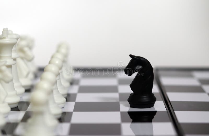 On a Chessboard, a Black Horse Encounters a White Chess Enemy. Stock ...