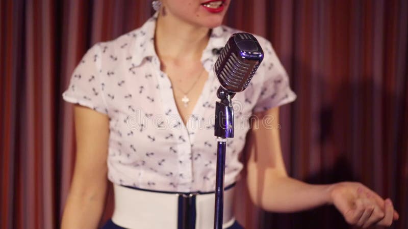 Chest and Arms of Young Woman Singing into Retro Stock Video - Video of ...