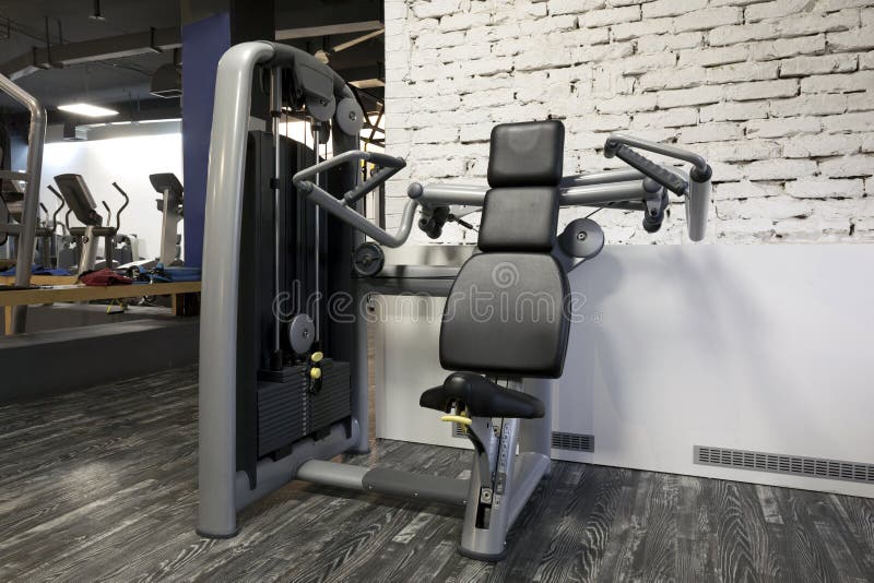 Chest press machine in gym stock image. Image of fitness - 54782775