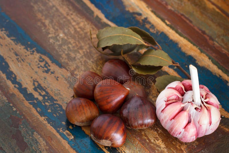 Chestnut, Garlic and Bay Leaf on Wooden Table Stock Photo - Image of ...