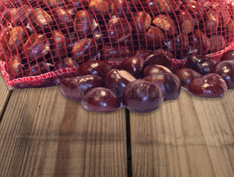 Chestnuts with Mesh Bag on the Table Chestnuts with Mesh Bag on the ...