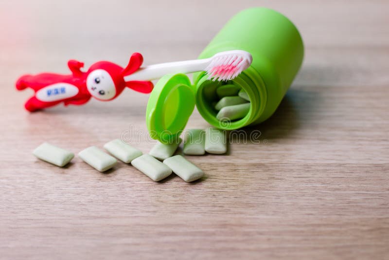 Chewing gum and toothbrush stock photo. Image of wooden - 106797736