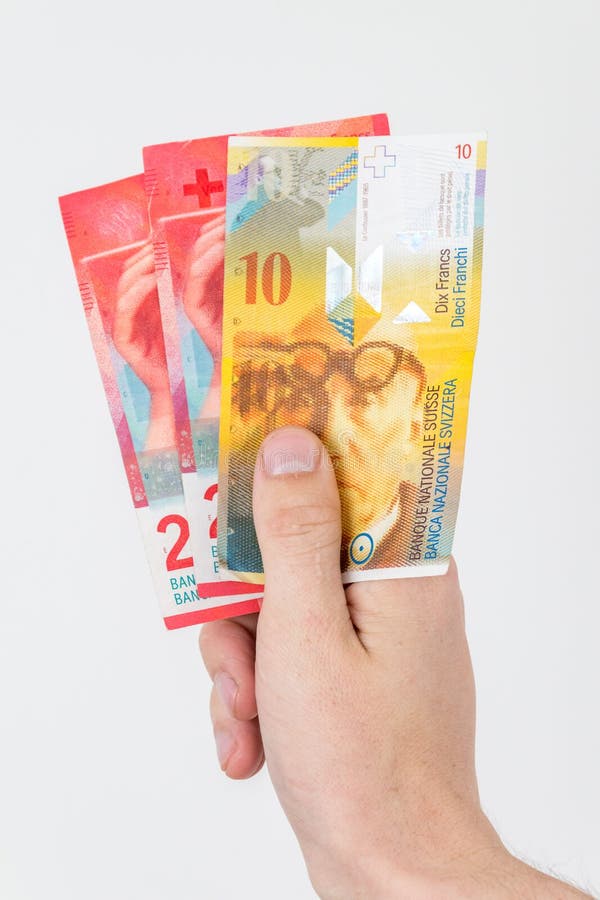 10 and 20 CHF Swiss Franc Banknotes in Hand Stock Photo - Image of male ...