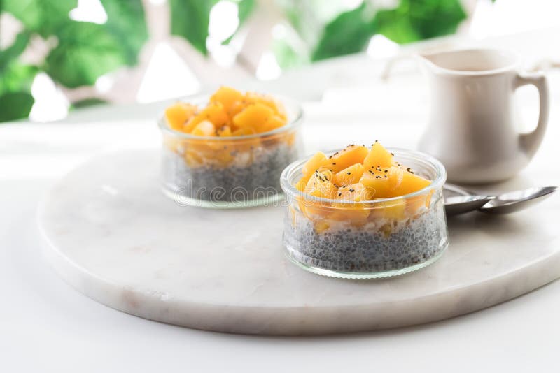 Chia Pudding Snacks Topped with Chopped Mango Against a Burry ...