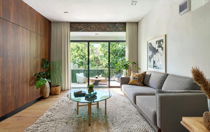 Chic Modern Living Room with Lush Greenery and Scenic Views Stock Image ...