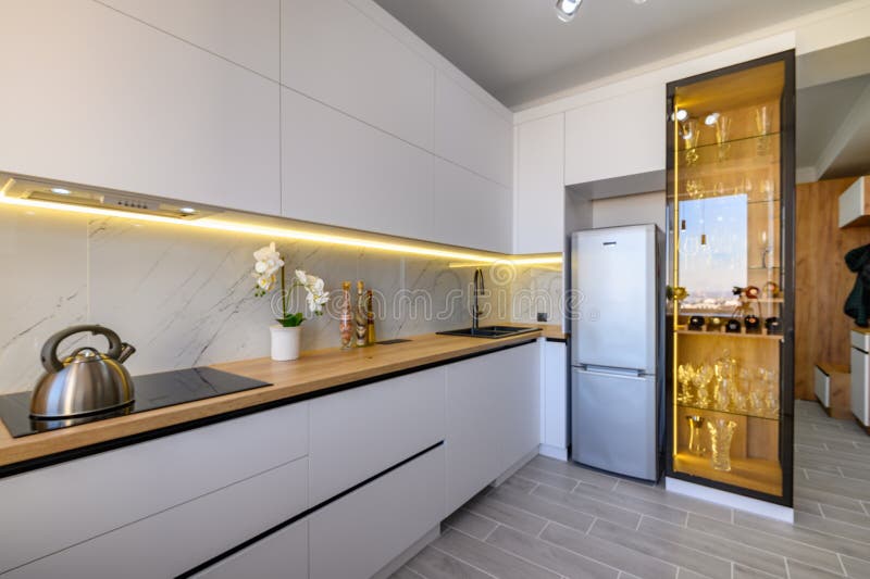 A Chic White Studio Apartment with a Fully Equipped Kitchen Stock Image ...