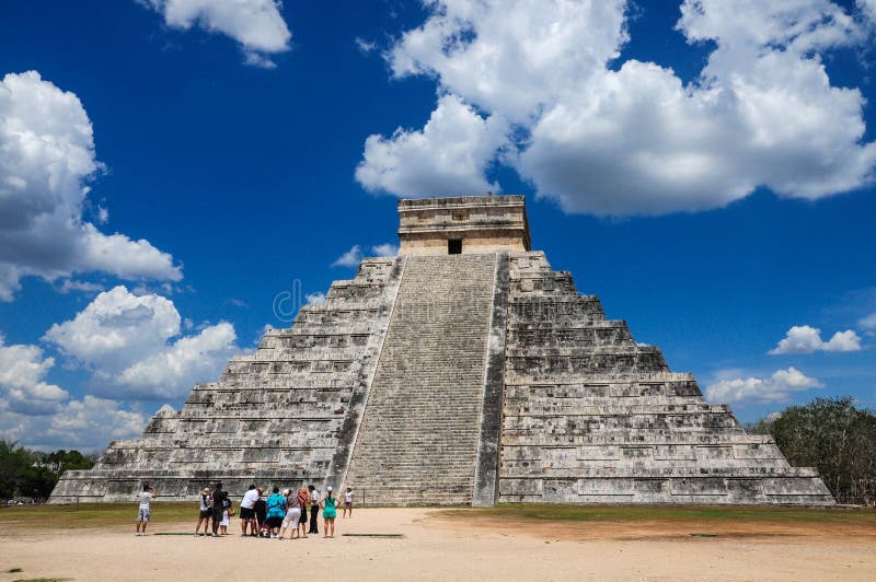 Visitors Explore the Ancient Chichen Itza Pyramid Under a Vibrant Blue ...