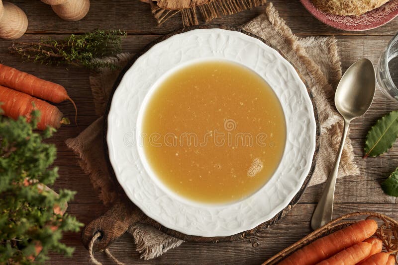 Chicken Bone Broth in White Plate on a Wooden Table Stock Photo - Image ...