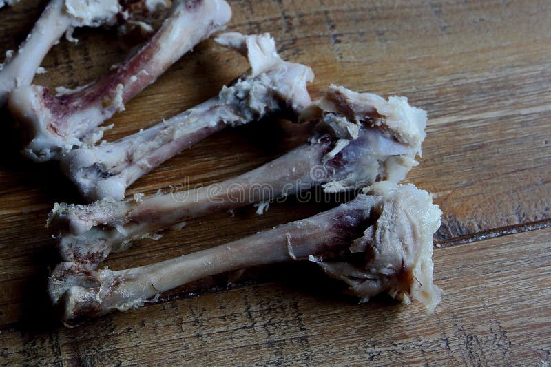 Chicken Bones with Meat Scraps on a Wooden Table Stock Photo - Image of ...
