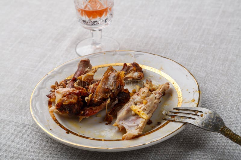 Chicken Bones on the Plate and Other Leftovers Left after Eating. Stock ...