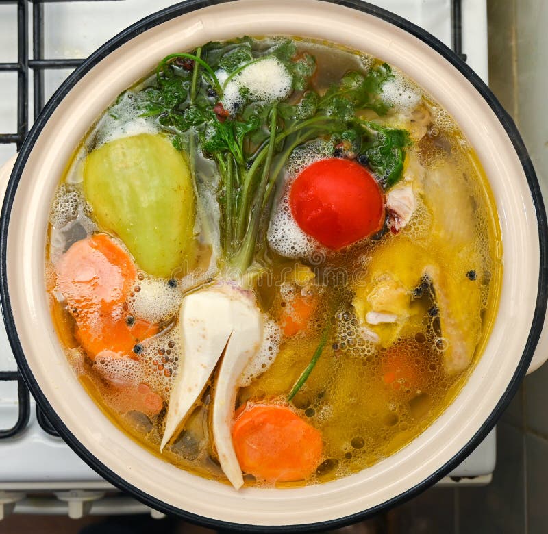 Chicken Broth with Pieces of Meat on Bone and Vegetables in Cooking Pot ...