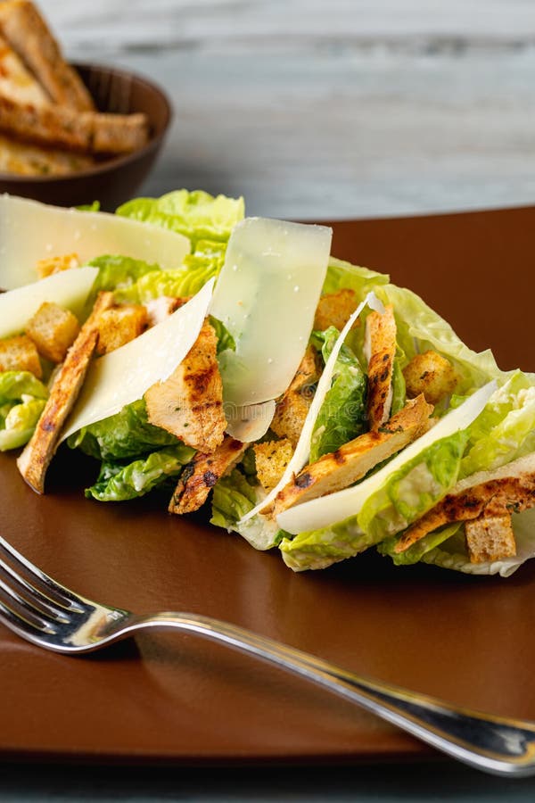 Chicken Caesar Salad Served on a Porcelain Plate with Crusty Bread ...