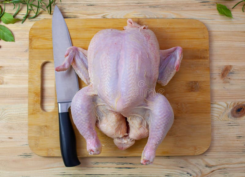Chicken Carcass on a Cutting Board Stock Photo - Image of knife, herbs ...