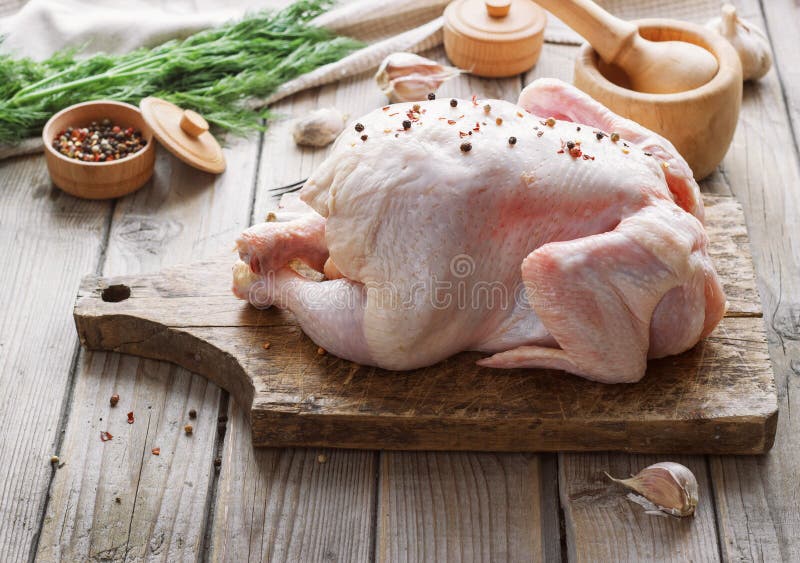 Chicken Carcass on a Wooden Background with Spices, Cooking in the ...