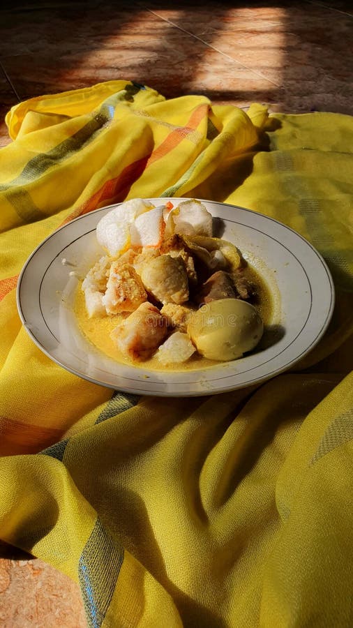 Chicken Cooked in Yellow Broth Served with Boiled Egg and Rice Cakes ...