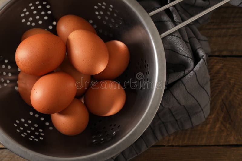 Chicken Eggs in Colander and Napkin on Wooden Table, Top View Stock ...