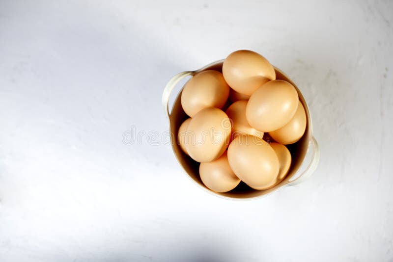 The Chicken Eggs in a Gray Plastic Basket the Back is a Black ...