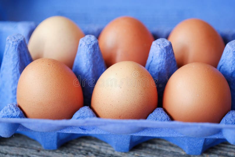 Chicken Eggs in the Purple Package on the Table Stock Image - Image of ...