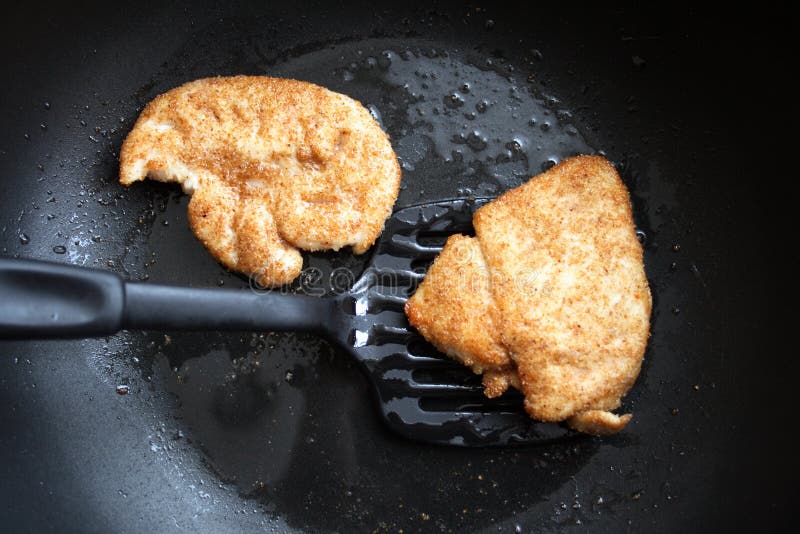 Chicken fillet on a frying stock photo. Image of yellow - 7834056