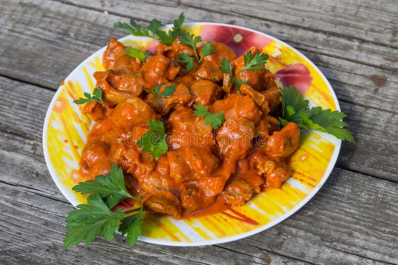 Chicken Gizzard Stew in Plate on Rustic Wooden Table Stock Photo ...