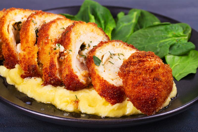 Chicken Kiev on Mashed Potato with Spinach. Stock Photo - Image of ...