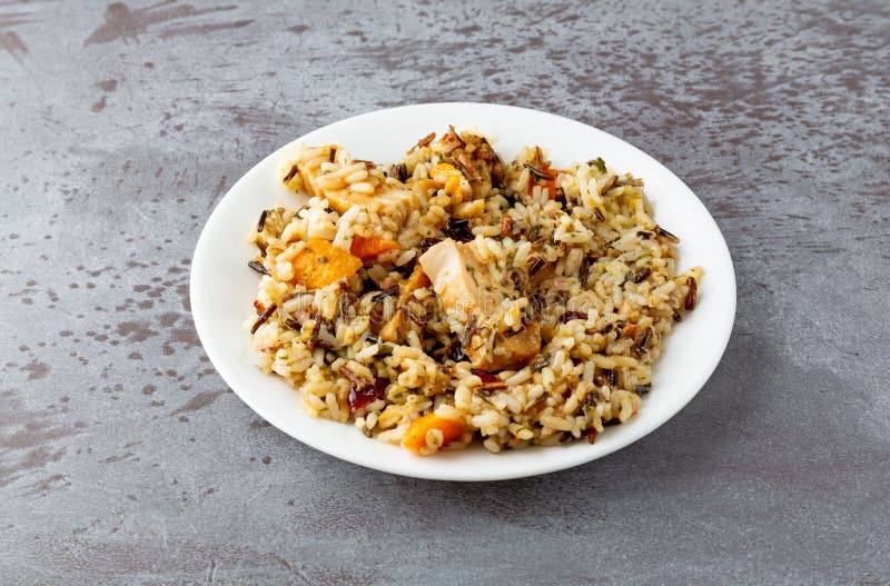 Chicken with Pecans and Wild Rice on a Plate on a Gray Background Stock ...