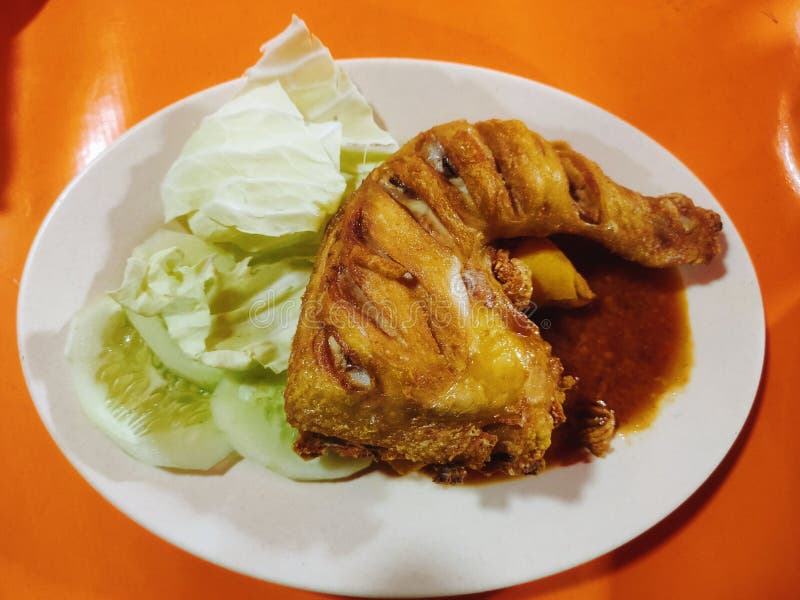 Chicken Pecel with Cucumber, Cauliflower and Chili Sauce on a Plate ...