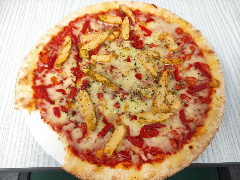 Chicken Pizza with a Bitten Off Piece on the Table Stock Image - Image ...