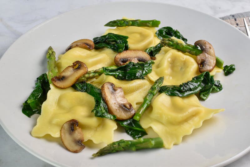 Chicken Ravioli Top with Asparagus, Mushromms and Spinac Stock Photo ...