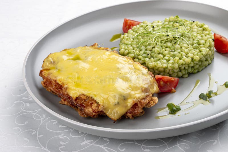 Chicken Schnitzel Under Cheese with Pittitimus. Isolated Image Stock ...