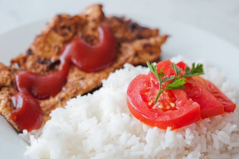 A Dish Of Chicken Steak Served With Fried Rice And Vegetable Stock ...