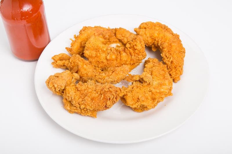 Chicken Strips on White Plate with Hot Sauce on Side Stock Photo ...