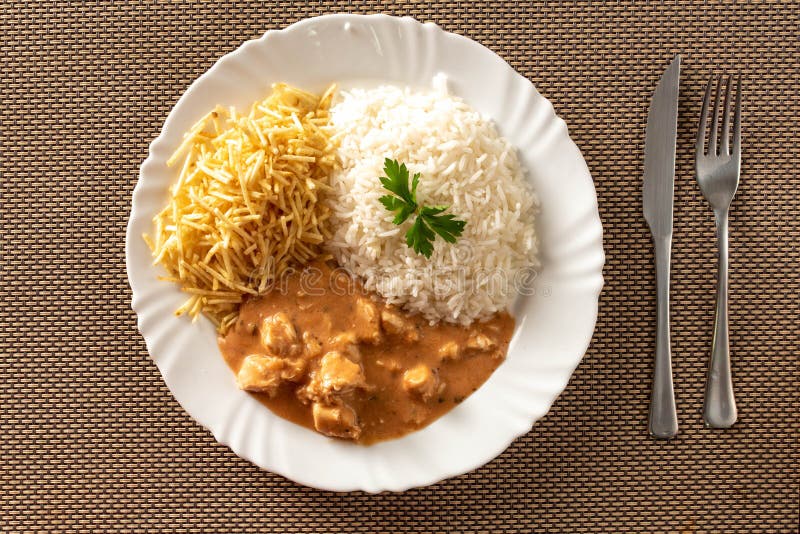 Chicken Stroganoff Accompanied with Rice, Salad and Potato Straw Stock ...