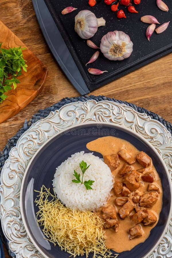 Chicken Stroganoff with Rice and Potato Straw Stock Image - Image of ...