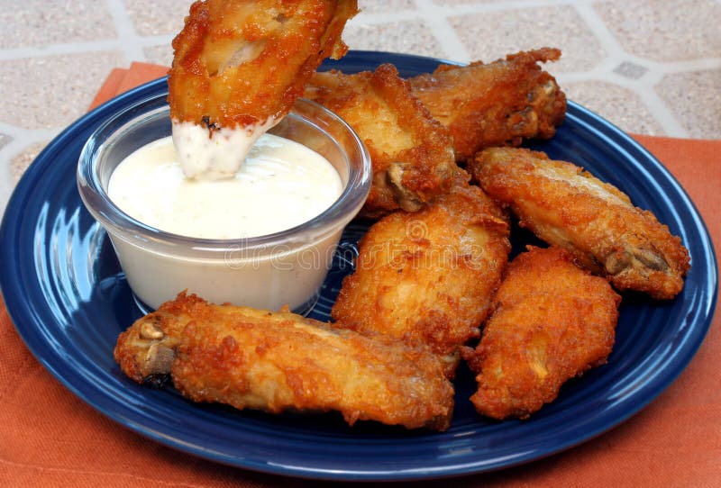 Chicken Wing Being Dipped stock photo. Image of treat - 6021540