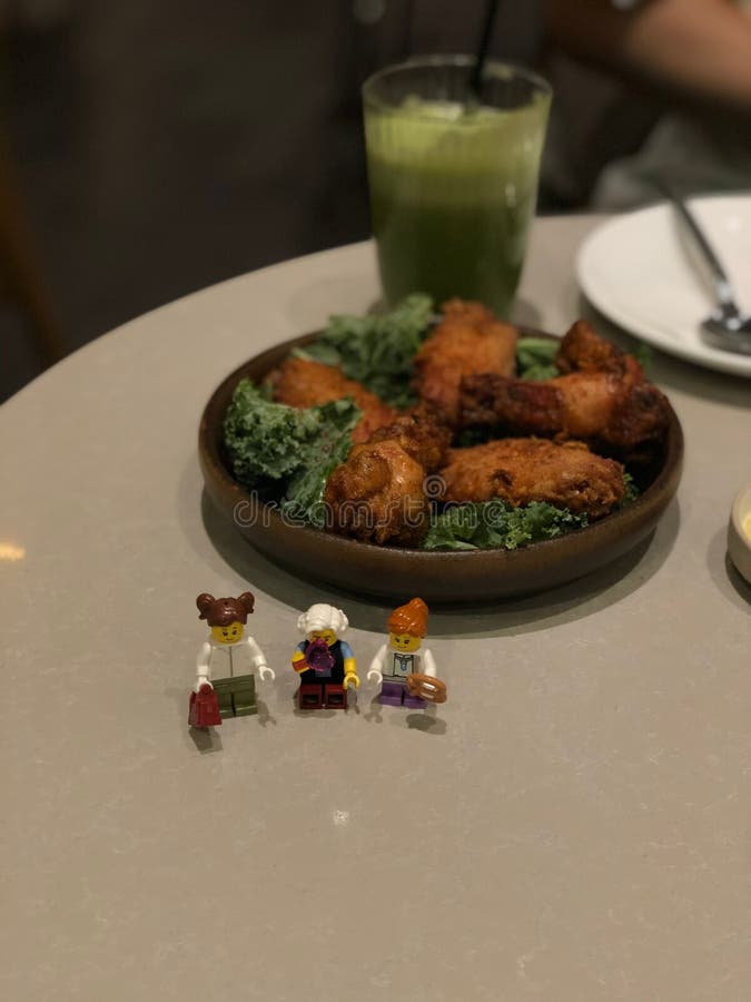 Chicken Wings and Lego Men on a Dining Table Editorial Photography ...