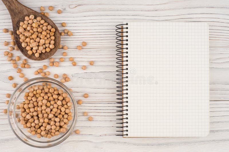 Chickpeas in a Glass Bowl with a Notebook on an Old Wooden Table Stock ...