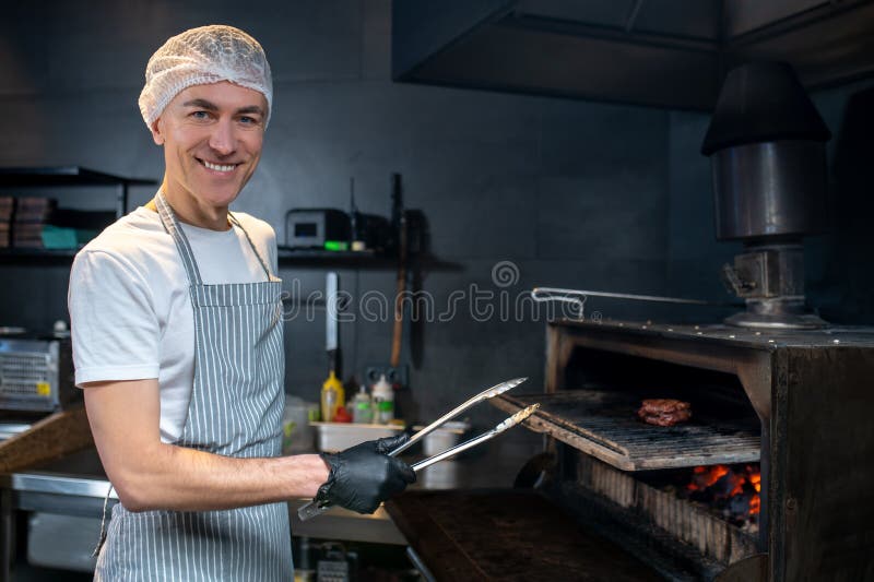 A Chief-cooker Cooking in the Kitchen in the Restaurant Stock Image ...