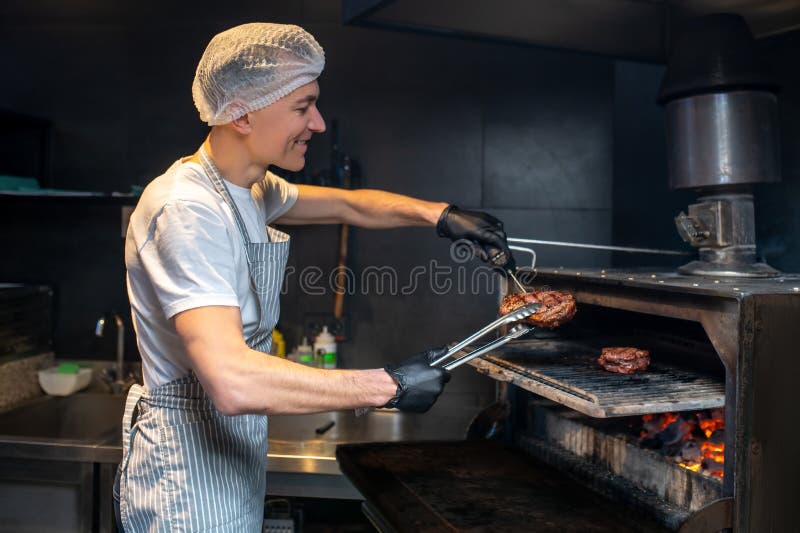 A Chief-cooker Working in the Kitchen in the Restaurant Stock Photo ...