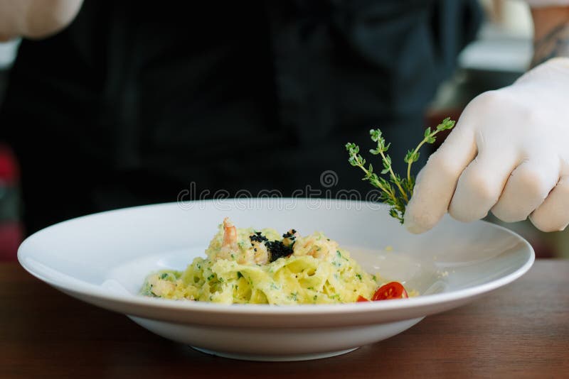 Chief Dressing Pasta with Black Truffle and Herbs. Stock Image - Image ...