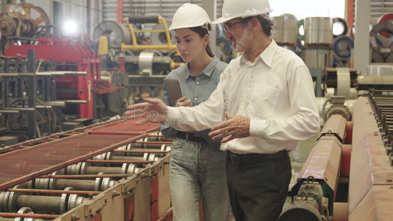 Chief Engineer Explaining Machine Operation To Executive in Heavy ...