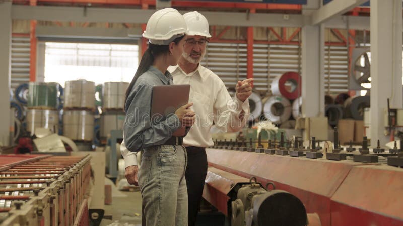 Chief Engineer Explaining Machine Operation To Executive in Heavy ...