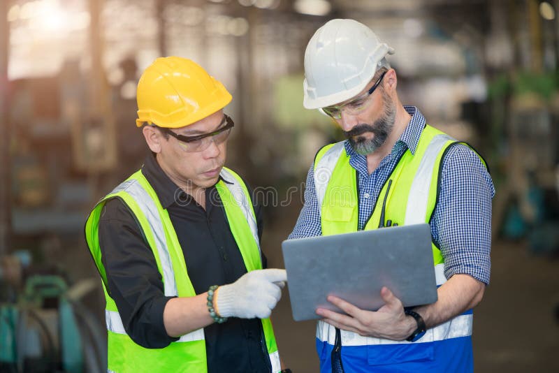 Chief Engineer Talking with Staff Worker Looking Detail in Laptop ...