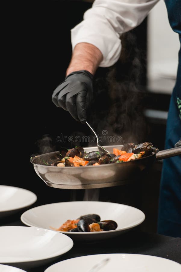 Chief in a Restaurant Cooking Seafood with Sauce Stock Image - Image of ...