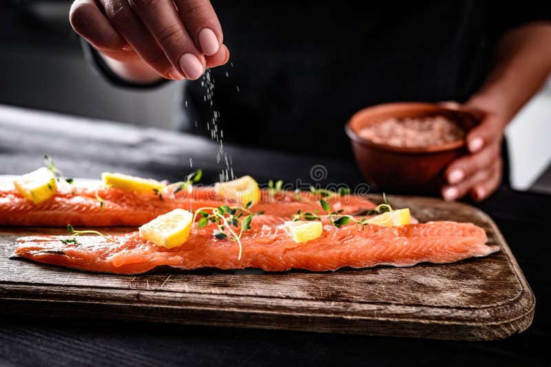 Chief Salting Raw Red Trout Fish for Cooking with Lemon Stock Image ...
